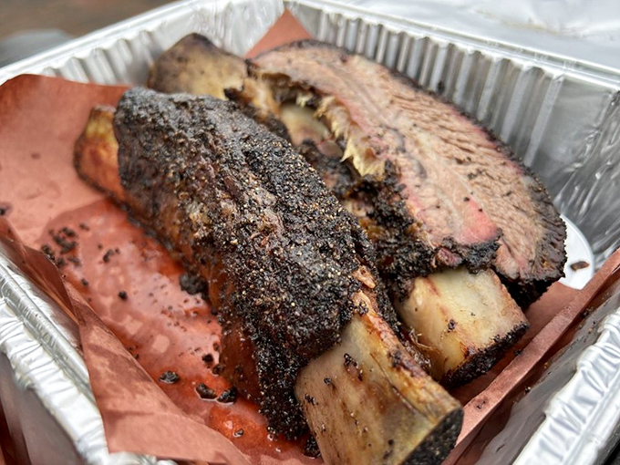 These beef ribs aren't just dinner—they're prehistoric monuments to smoke and patience. Fred Flintstone would weep with joy.