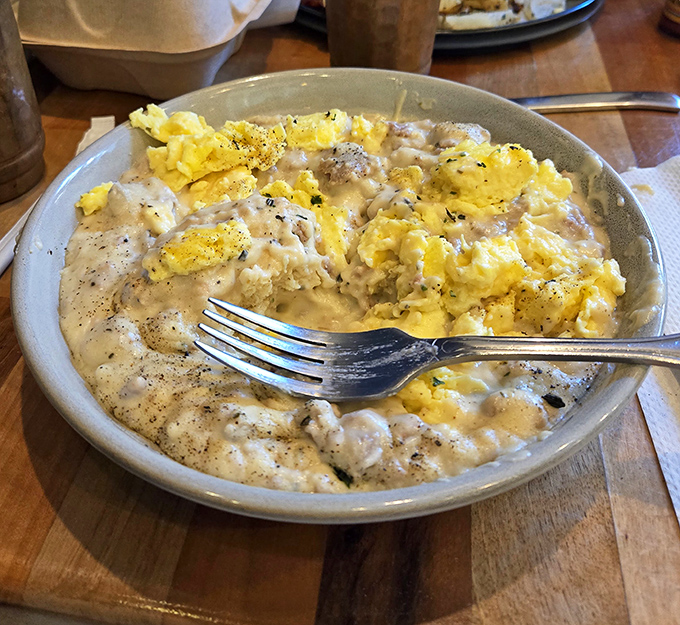 Behold the star of the show: biscuits swimming in peppery sausage gravy with scrambled eggs playing the delicious supporting role. Breakfast nirvana achieved.