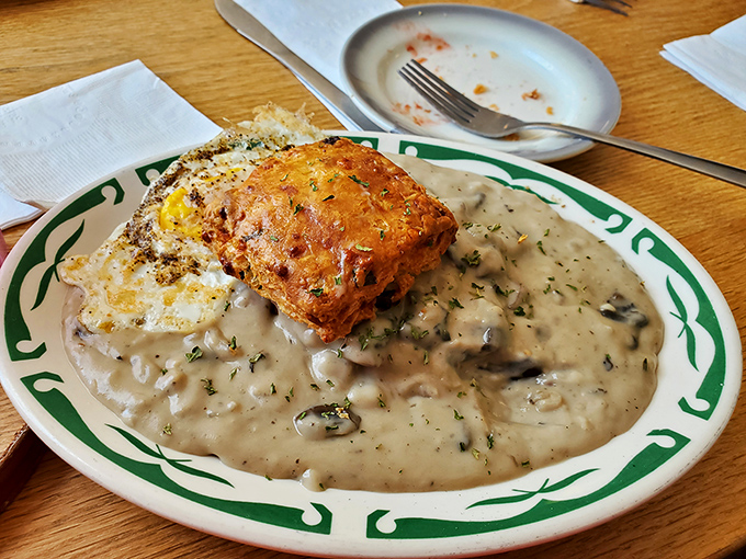 This isn't just biscuits and gravy &ndash; it's a warm hug on a plate, with that golden-brown biscuit island rising from a sea of creamy, herb-flecked goodness.