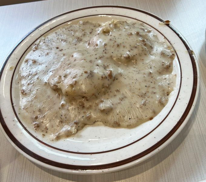 Behold the holy grail of breakfast: biscuits drowning in peppery sausage gravy that could make a grown adult weep with joy.