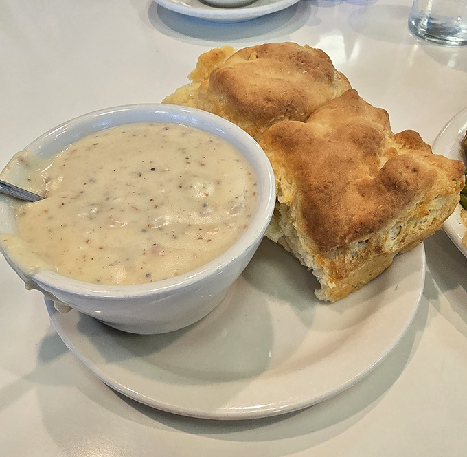 Behold the holy grail: fluffy buttermilk biscuits drowning in creamy sausage gravy that'll convert any skeptic.