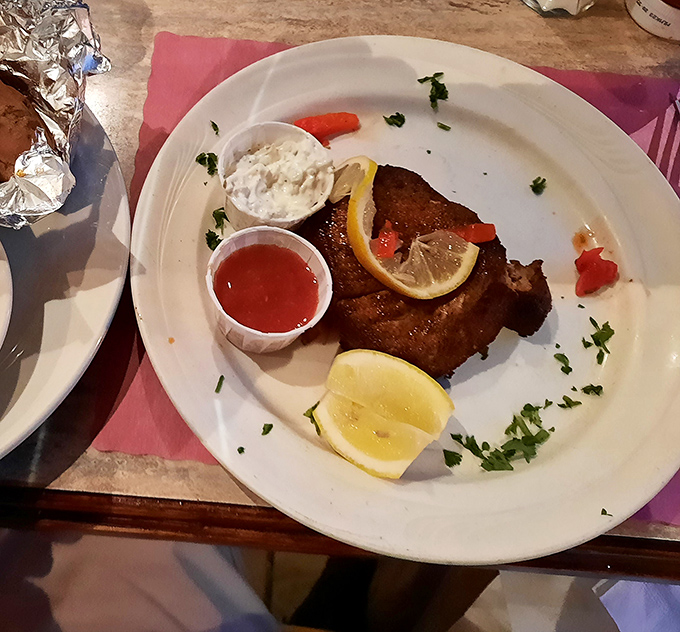 This blackened fish isn't just dinner &ndash; it's theater on a plate, complete with lemon wedges playing supporting roles to the perfectly seasoned star.