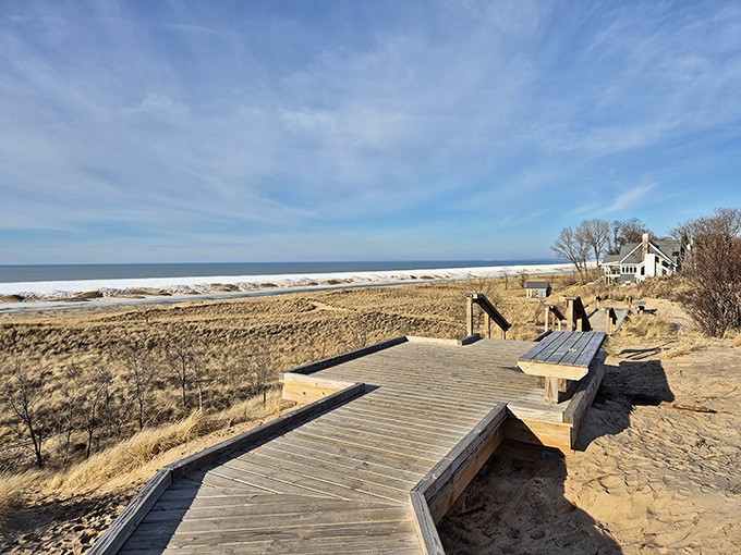 The boardwalk whispers, "This way to tranquility," guiding visitors through dunes to where the horizon stretches like possibility itself.