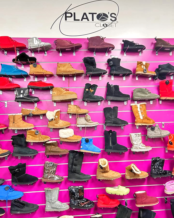 A vibrant display of boots on hot pink shelving&mdash;like a dessert case for your feet, but without the calories.