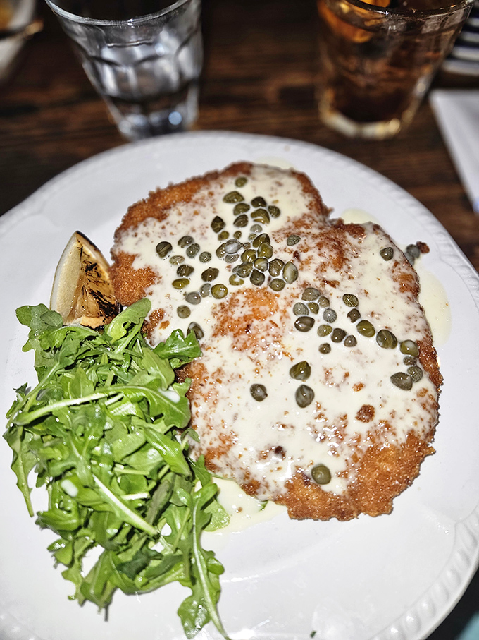 The star of the show: breaded pork loin that's crispy, tender, and topped with capers. This isn't just dinner&mdash;it's edible architecture with a side of arugula.