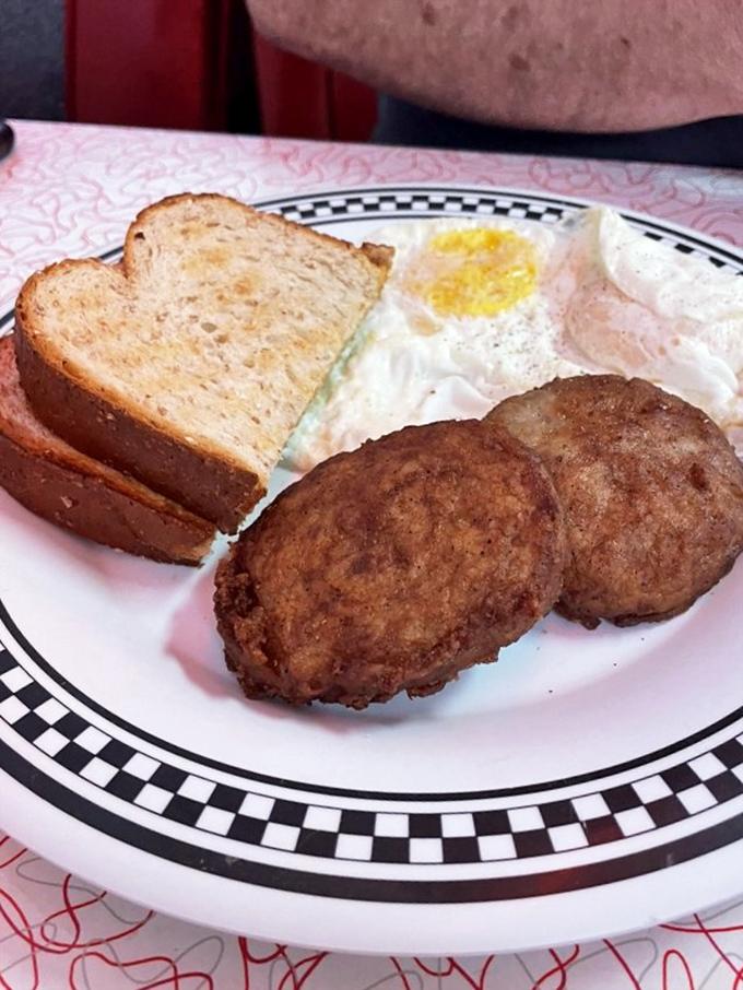 Simple perfection on a plate: golden sausage patties, eggs with sunshine-yellow yolks, and toast waiting for its butter bath. Breakfast doesn't need to be complicated to be extraordinary.