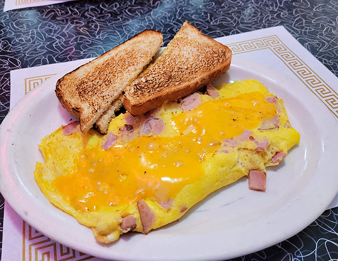 This ham and cheese omelet doesn't need fancy plating to impress&mdash;just perfectly fluffy eggs, generous fillings, and toast that's actually toasted right.