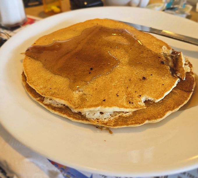 Golden-brown pancakes glistening with maple syrup—the kind that make you wonder why anyone would ever skip breakfast. Pure morning bliss.