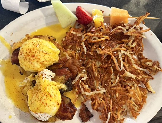 Eggs Benedict that would make a cardinal sin. The hollandaise sauce practically performs a victory lap around those perfectly poached eggs.