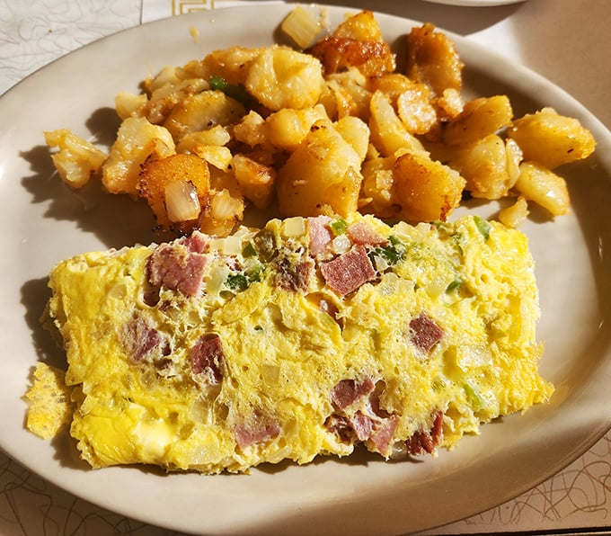 This ham omelet and home fries combo isn't just breakfast—it's edible therapy. Golden potatoes with crispy edges and a fluffy egg creation that puts your sad protein shake to shame.