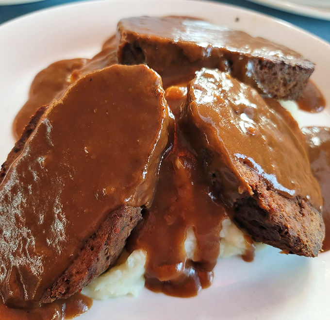 Comfort food perfection arrives drizzled in rich gravy that could make your grandmother jealous of her own recipes.