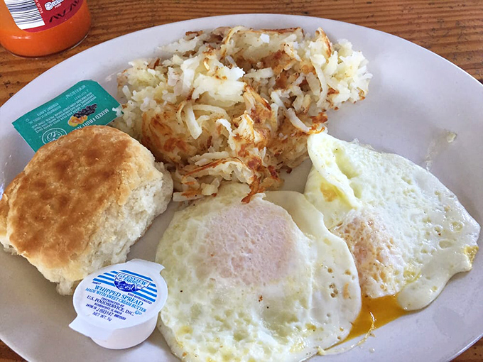 Breakfast nirvana achieved: golden hash browns, perfectly cooked eggs, and a biscuit that would make your grandmother both proud and jealous.