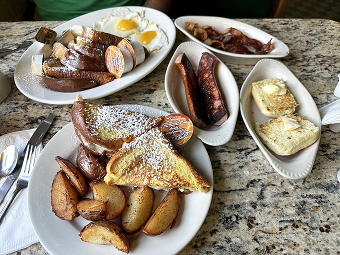 Breakfast nirvana achieved: French toast dusted with powdered sugar, eggs with perfect sunny centers, and home fries that could make a potato proud.