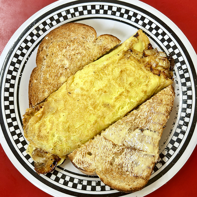 Behold the omelet that launched a thousand satisfied sighs&mdash;perfectly folded, generously filled, and flanked by toast that's achieved golden-brown perfection.