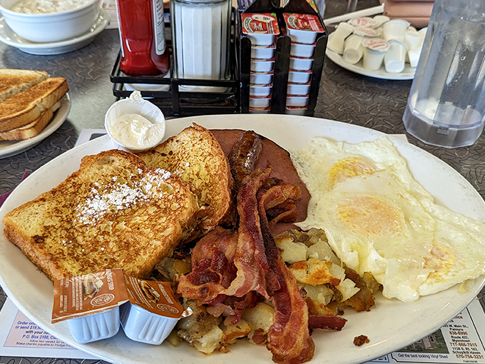 Breakfast of champions—or anyone who appreciates that perfect sunny-side up egg. The French toast's golden crust whispers sweet nothings to those crispy bacon strips.