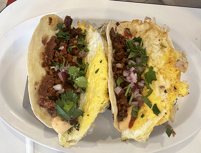 Breakfast tacos that mean business – perfectly scrambled eggs, seasoned meat, and fresh toppings create that "why don't I make these at home?" moment.