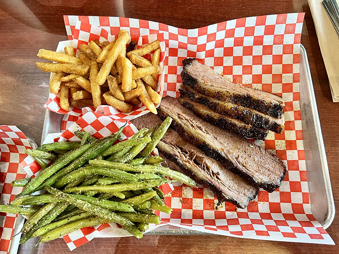 Perfectly sliced brisket with French fries and green beans. That bark! That smoke ring! That moment when you realize vegetables are just plate decorations.