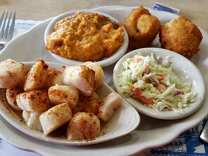 Broiled scallops that would make Neptune himself weep with joy, served with sides that know their supporting role in this seafood symphony.