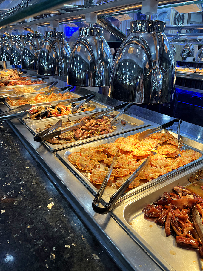 Those gleaming buffet stations stretch like a culinary highway, promising endless discoveries under every warming lamp.