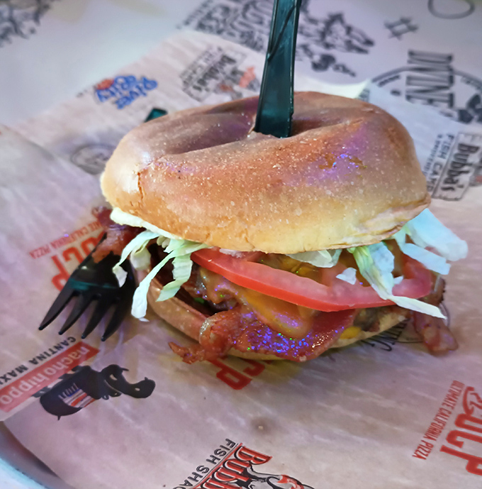 This isn't just a burger; it's an architectural marvel of beef, cheese, and fresh veggies that requires both hands and zero shame.