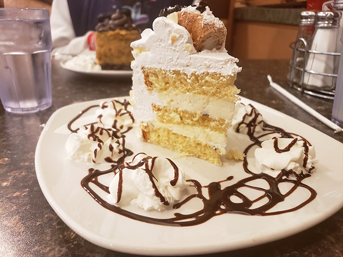 Layer upon heavenly layer of vanilla cake with cream filling, artfully drizzled with chocolate. Diet plans come here to die beautiful deaths.