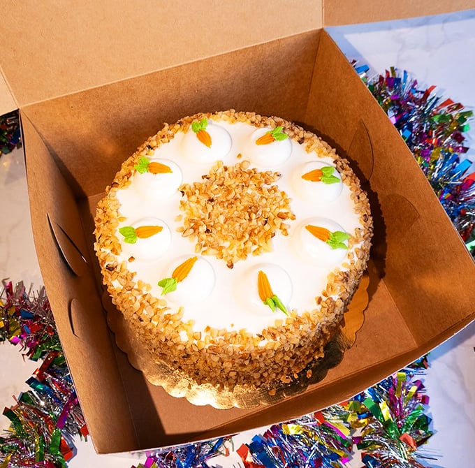 This carrot cake isn't just dessert, it's architecture. Those perfectly placed walnuts and delicate carrot decorations are basically edible modern art.