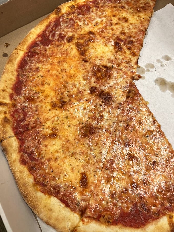 Pizza perfection in its purest form. This cheese pizza's golden bubbles and perfect sauce-to-cheese ratio explain why locals make weekly pilgrimages here.