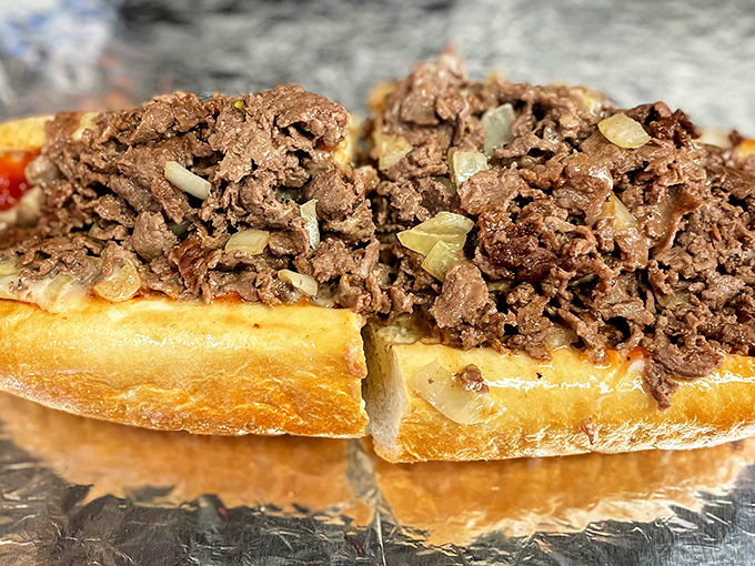 Behold the star of the show: thinly chopped ribeye mingling with caramelized onions on a perfect roll. Poetry in sandwich form.