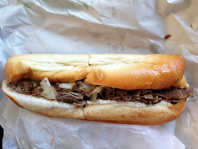 The cheesesteak in its natural habitat&mdash;perfectly nestled in a fresh roll with onions playing their supporting role to perfection.