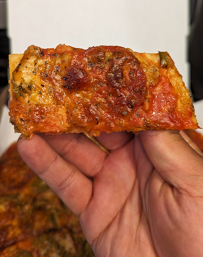 The square-cut slice – Chicago's true pizza tradition. Crispy, cheesy, and requiring no engineering degree to eat while standing.