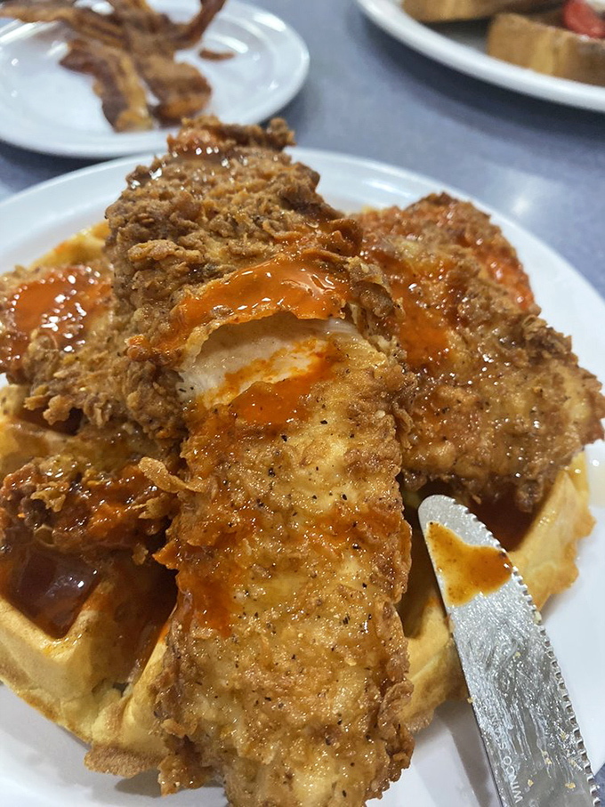 Chicken and waffles: where crispy meets fluffy in a relationship that makes more sense than most Hollywood marriages. The hot sauce drizzle is non-negotiable.