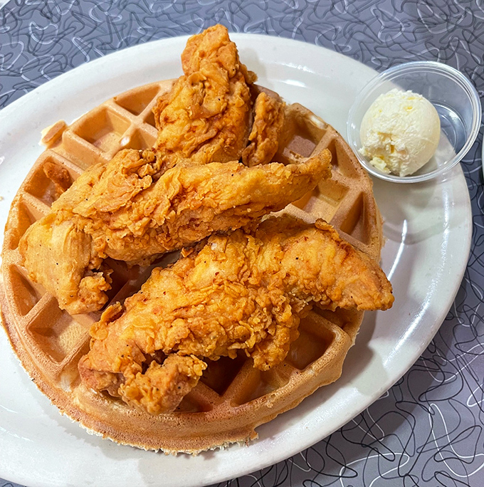 Chicken and waffles &ndash; the breakfast equivalent of a perfect marriage. Crispy golden chicken perched atop a fluffy waffle with a side of butter.