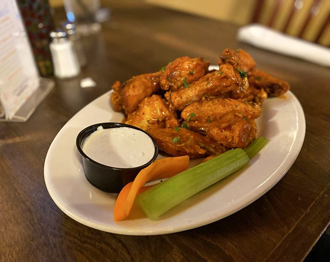 These aren't just wings; they're crispy little messengers of joy, glistening with sauce and served with the kind of celery sticks that suddenly seem essential to happiness.