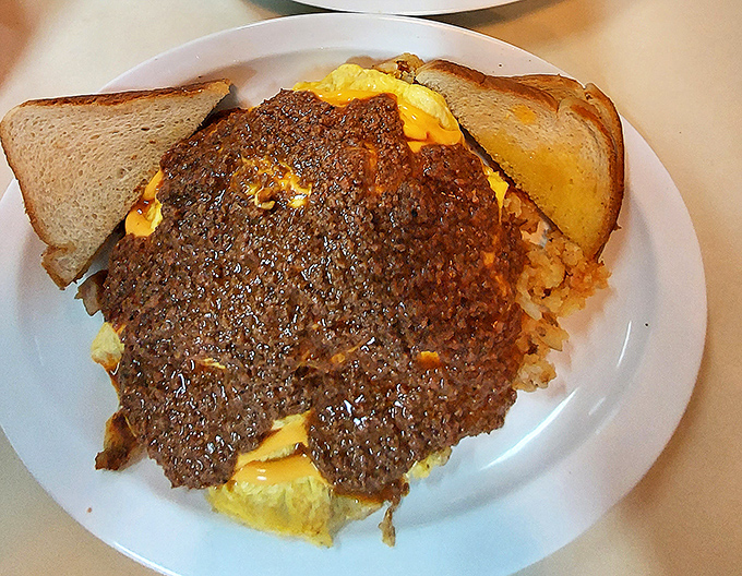 Chili so hearty it could patch potholes in winter. Smothering eggs and toast, it's breakfast transformed into a warm embrace.