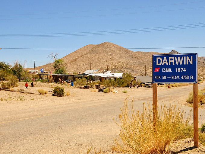 The town marker stands proudly, like a passport stamp to a country time forgot. Population: enough for a poker game.