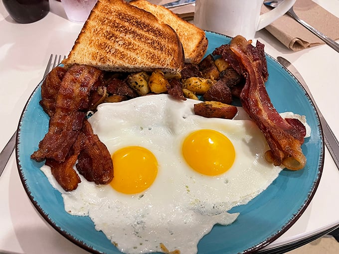 Two sunny-side up eggs stare back at you like old friends, while crispy bacon stands at attention. This isn't just breakfast&mdash;it's morning salvation.