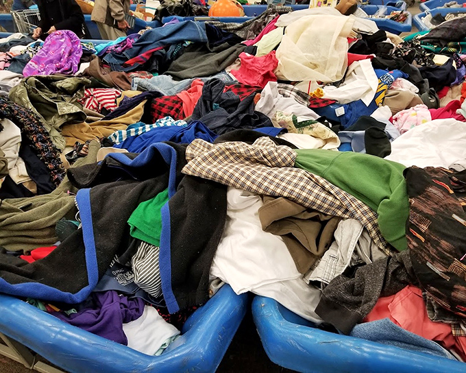 Textile mountain range where patient diggers strike gold. Somewhere in this fabric landscape lurks a cashmere sweater with your name on it.