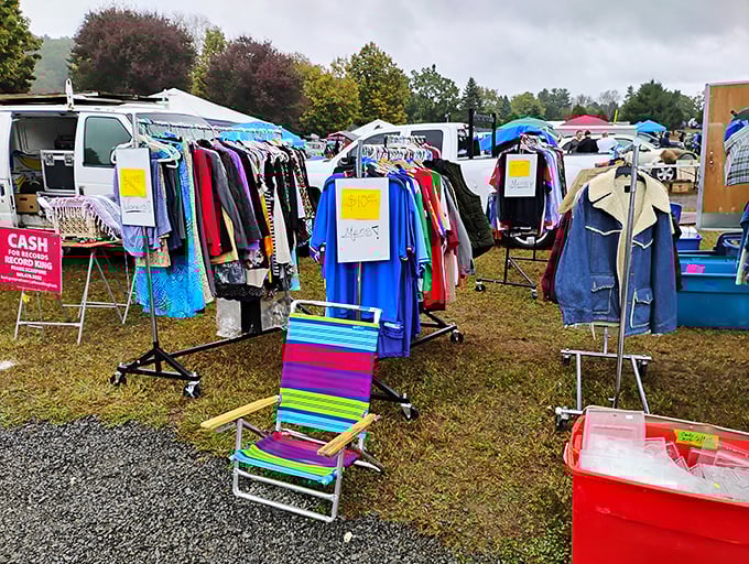 Fashion archaeology at its finest. Racks of clothing waiting for their second act, with that colorful beach chair standing by for when shopping fatigue hits.