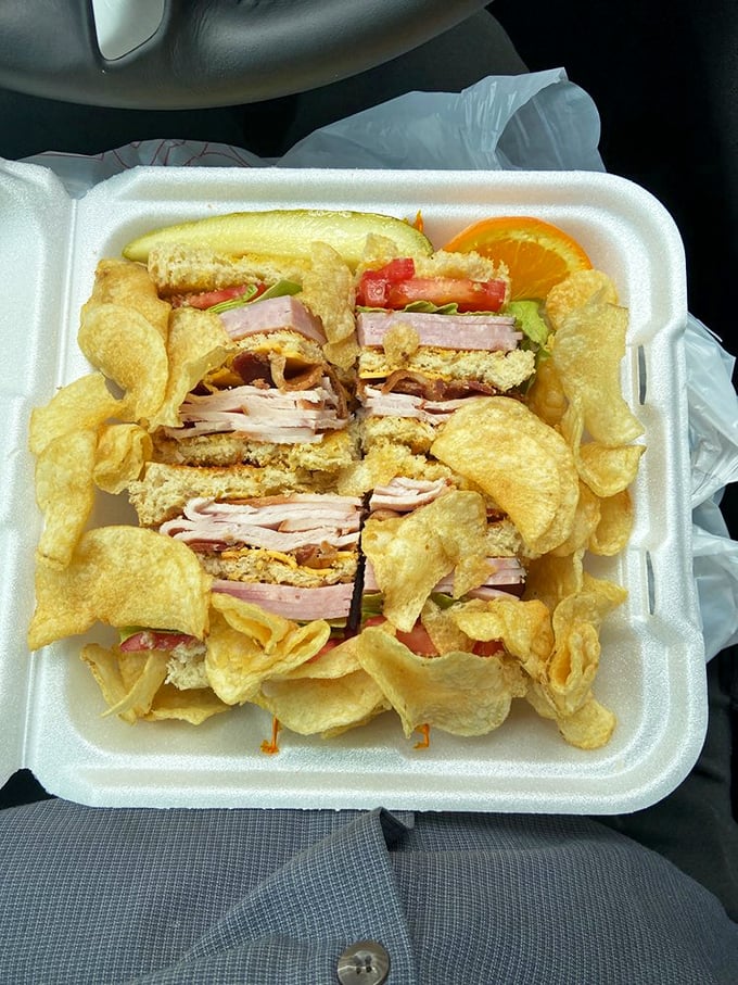 This club sandwich isn't playing around &ndash; stacked higher than my college debt and surrounded by a golden moat of potato chips.