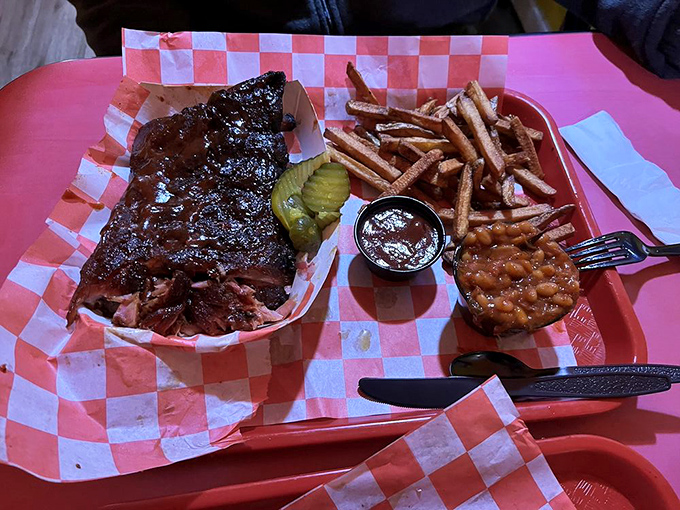 Behold the holy trinity of barbecue bliss: fall-off-the-bone ribs with that perfect bark, crispy fries, and beans that didn't come from any can.