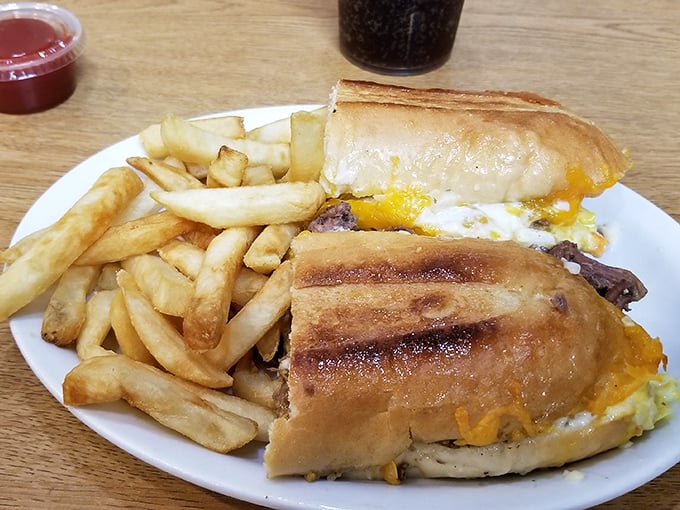 A sandwich that requires engineering skills to eat properly, paired with golden fries that crackle with each bite. Pure lunchtime bliss.