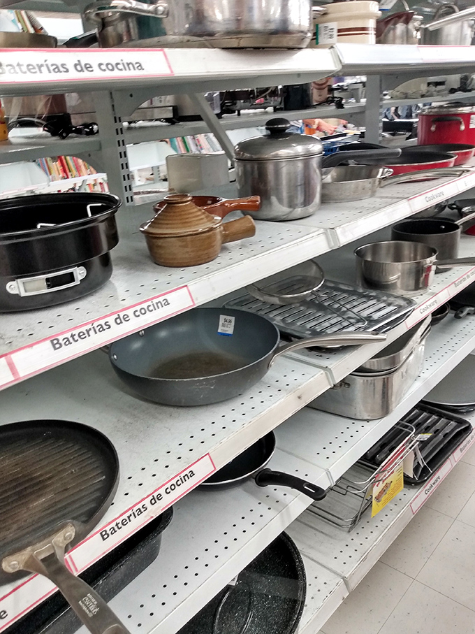 Cookware heaven! Pots and pans of every vintage await their second act in someone's kitchen drama.