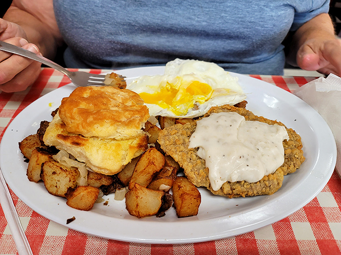 Country fried steak that could make a vegetarian weep. That golden biscuit, those perfect home fries, and gravy that deserves its own fan club.