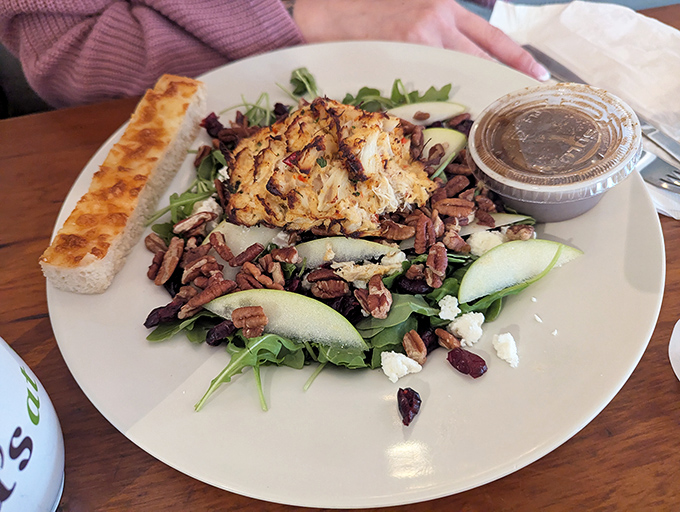 This isn't just any salad&mdash;it's a carefully orchestrated symphony of greens, nuts, and what appears to be crab cake, proving Pennsylvania knows its seafood game. 