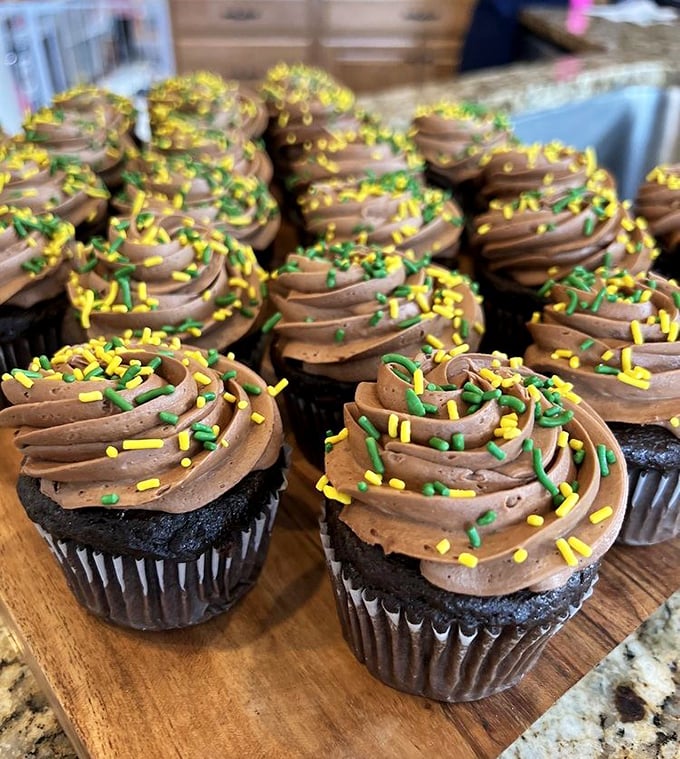 Chocolate cupcakes with perfectly piped frosting and festive sprinkles&mdash;architectural marvels of buttercream that somehow manage to look both elegant and playfully approachable.