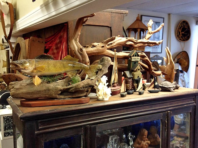 Nature meets nostalgia in this display where a mounted fish swims eternally above miniature birdhouses and driftwood sculptures.