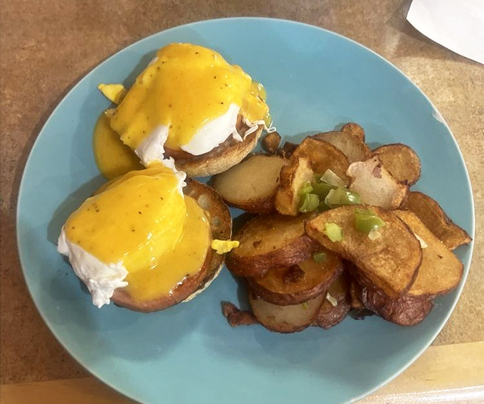 Behold: the Eggs Benedict that justifies the journey. That hollandaise sauce isn't just yellow&mdash;it's liquid sunshine on a plate.