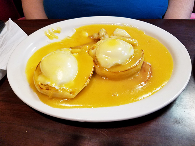 Behold the star attraction: Eggs Benedict swimming in hollandaise so golden it could fund your retirement. Worth every calorie.