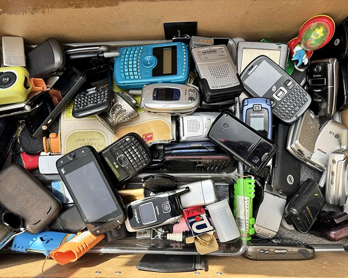 The archaeological dig of our digital past—a tray of forgotten cell phones that once represented cutting-edge technology now waits for collectors or nostalgic millennials.
