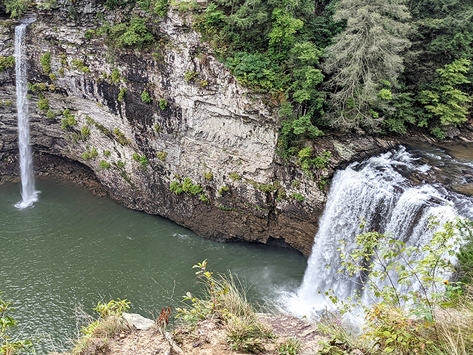 Mother Nature's two-for-one special: twin waterfalls carving through ancient limestone, performing a geological symphony that's been millions of years in the making.